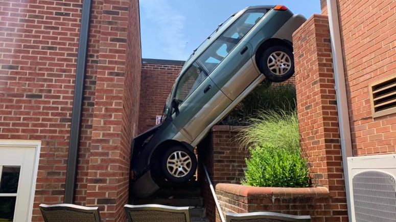 Driver rescued after crash leaves car wedged between buildings - Boston ...