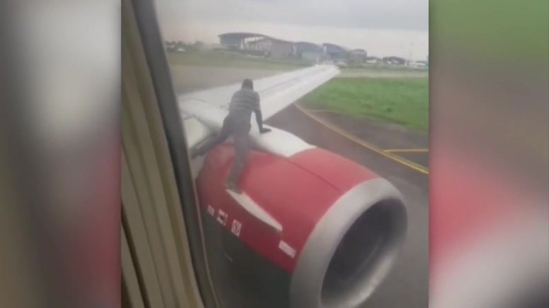 Man climbs onto plane wing before takeoff at Nigeria airport - Boston ...