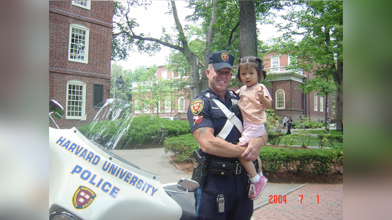 15 years ago a Harvard police officer posed with a toddler on campus ...