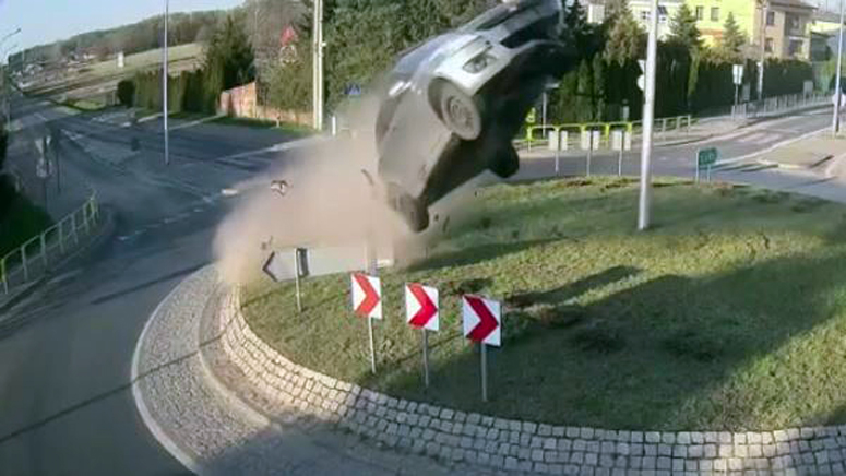 Video shows car going airborne over roundabout before crash-landing in ...