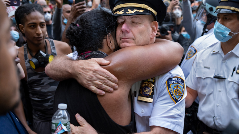 Police officers are joining protesters for prayers and hugs in several ...