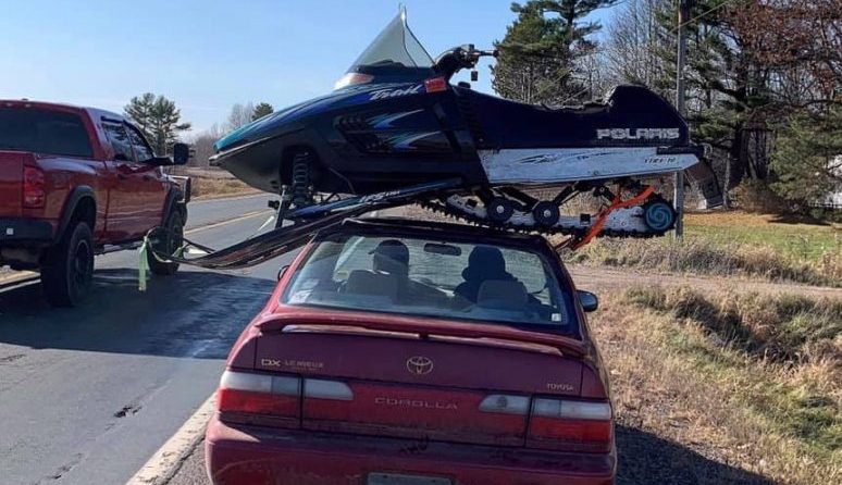 ‘Don’t try this at home’: Trooper stops driver with snowmobile on top ...