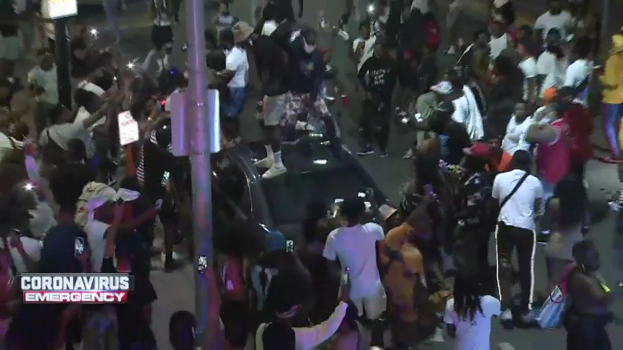 Miami Beach officers shoot pepper balls into spring break crowds to enforce emergency curfew ...