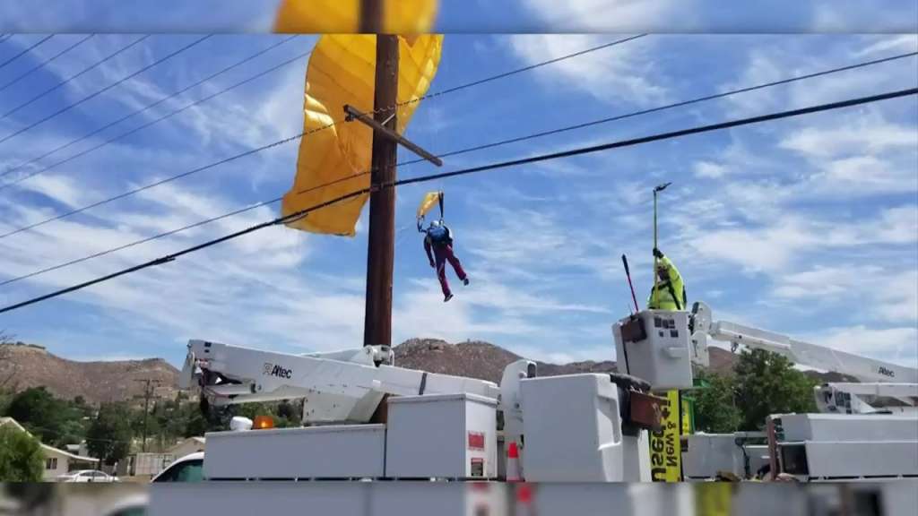 Person stuck 30 feet above ground after parachute becomes tangled in ...