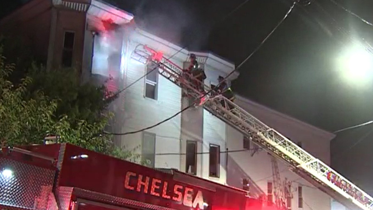 Firefighters battle heat and flames at large apartment building in ...