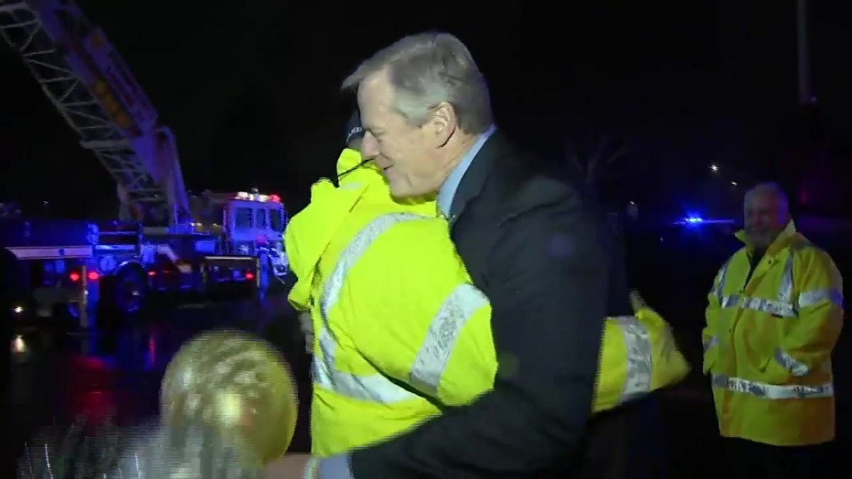 Neighbors gather to greet Gov. Charlie Baker as he returns to his ...
