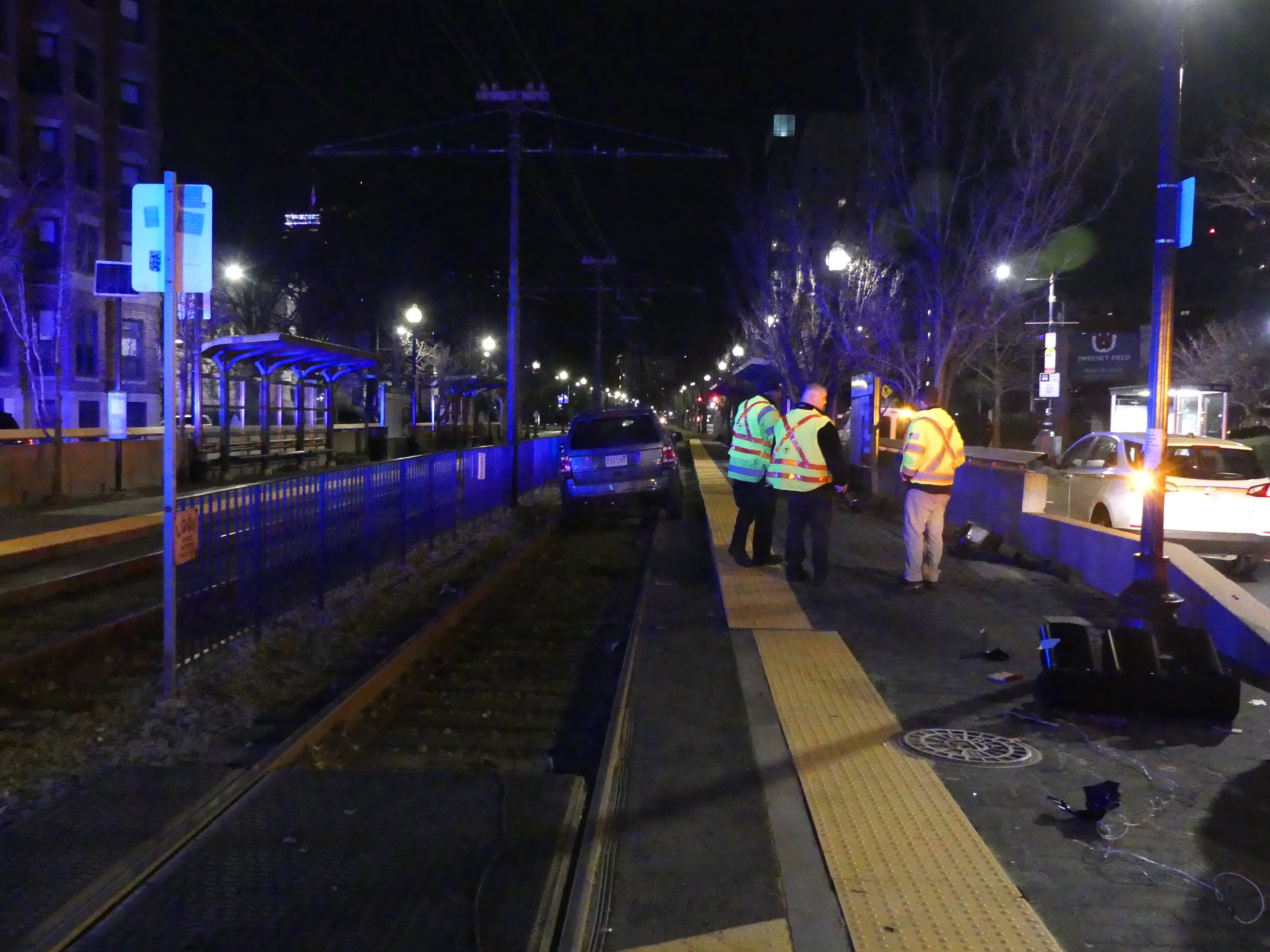 Police: Driver crashes after running red light, lands on MBTA Green ...