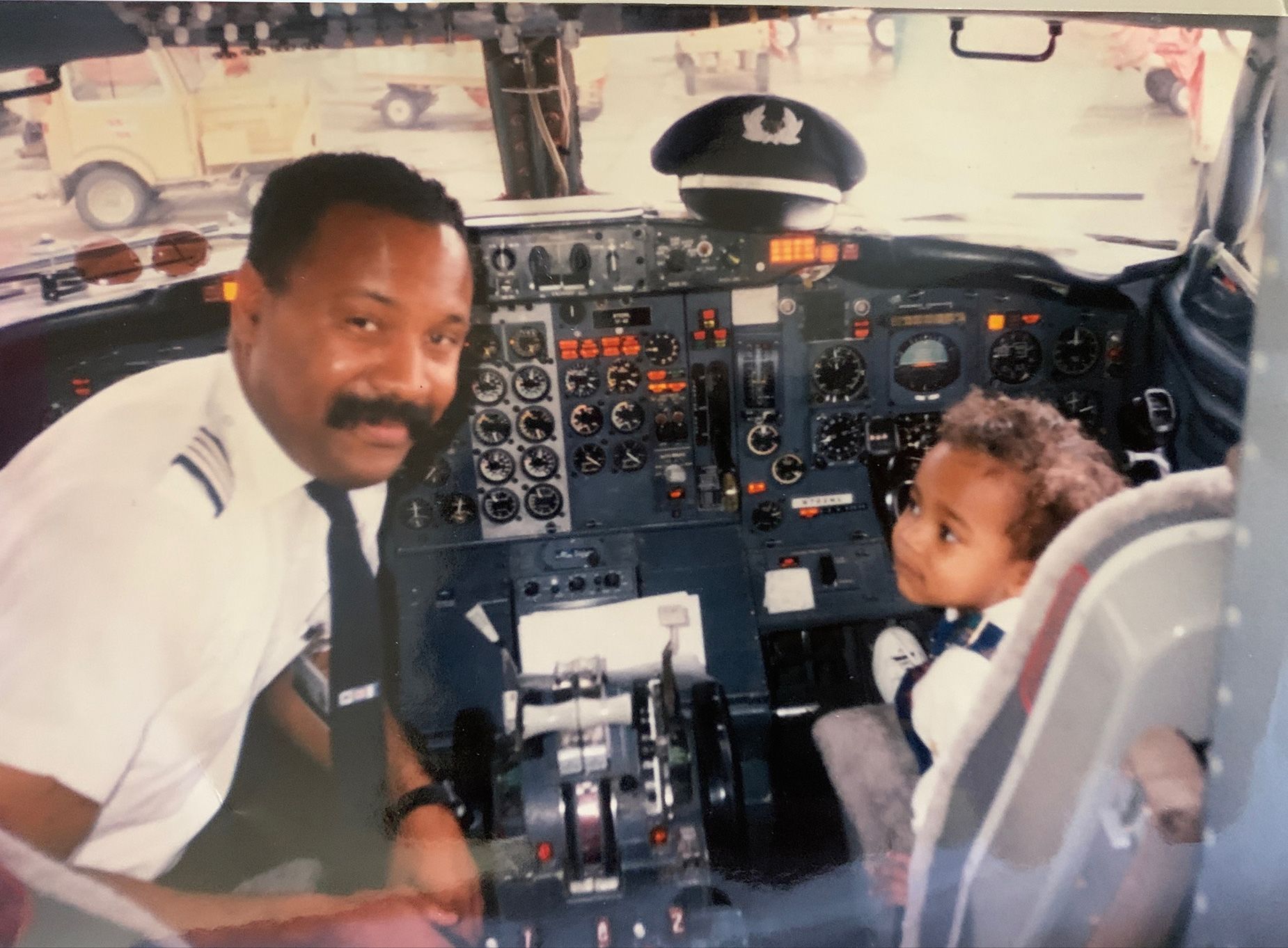 A kid posed with his pilot dad in an airplane. Almost 30 years later ...