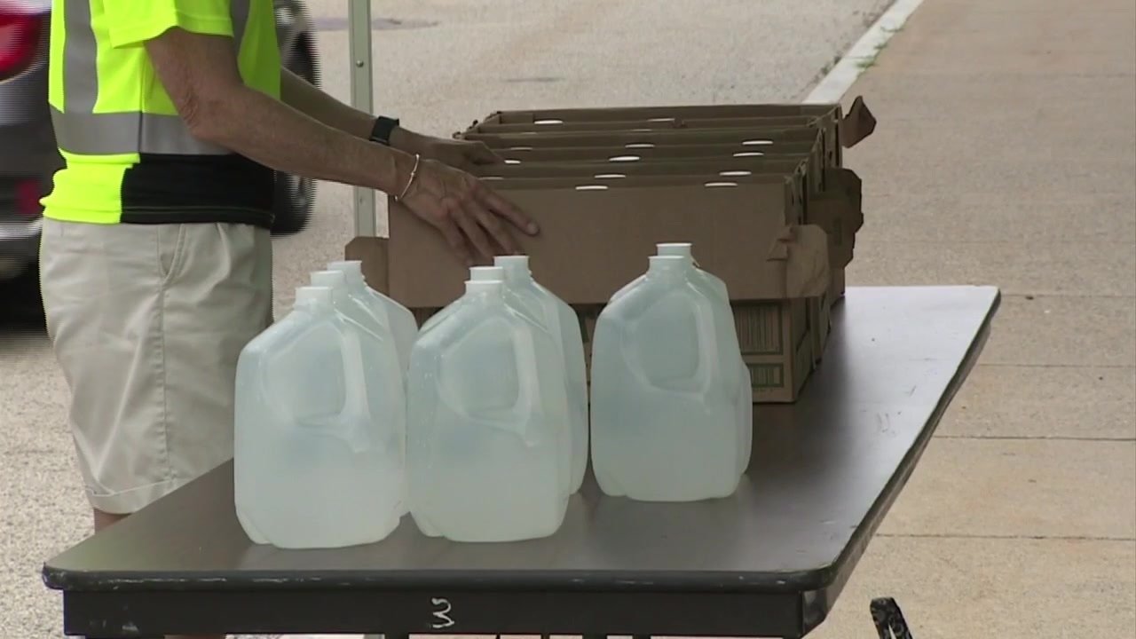 Officials hand out water bottles to South Shore residents reporting ...