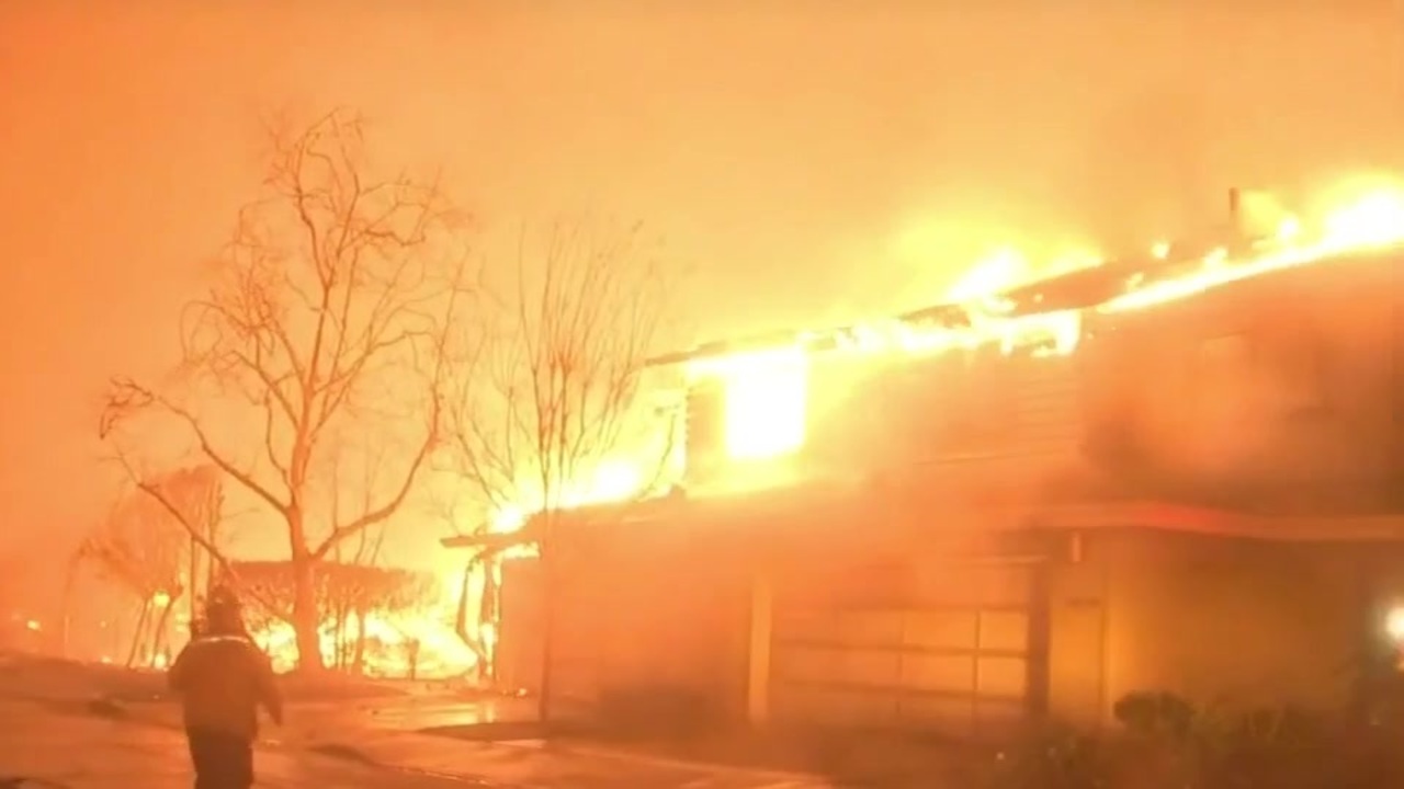 Wildfires burn out of control across Los Angeles area and kill 5 as thousands flee homes ...