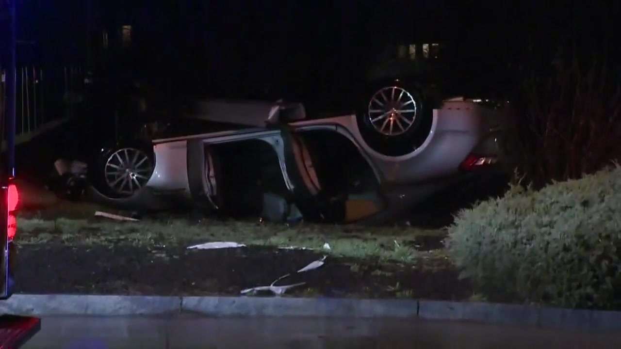 Driver hospitalized after car hits sign, building before flipping over ...