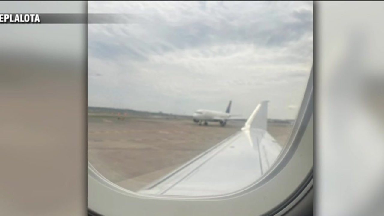 The wing tip of an American Airlines plane strikes another aircraft at ...