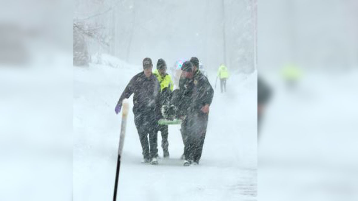 Paramedics carry patient injured in snowblower accident in Cohasset ...